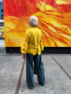 Golden yellow blouse as a jacket against murals - No Fear of Fashion