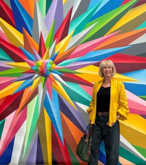 Golden yellow blouse as a jacket against murals - No Fear of Fashion