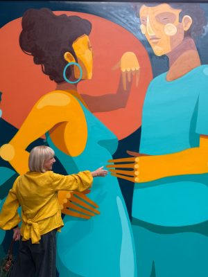 Golden yellow blouse as a jacket against murals - No Fear of Fashion