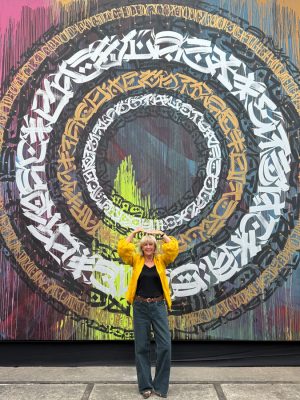 Golden yellow blouse as a jacket against murals - No Fear of Fashion